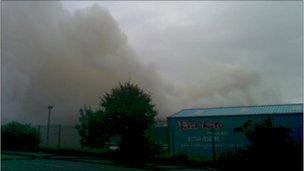 St Helens scrap wood fire burns for second day - BBC News