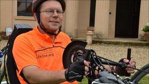 Hand-cycling paraplegic raises money for charity - BBC News