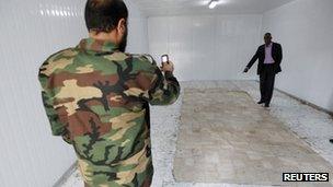 Muammar Gaddafi buried: End of gruesome show - BBC News