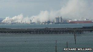 Dock fire dies down helped by wind and heavy rain - BBC News
