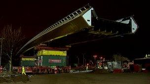 Trouble-hit Golden Bridge installed over A9 in Inverness - BBC News