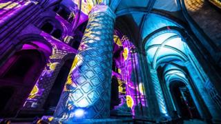 Durham Cathedral interior illuminated in stunning colours - BBC News