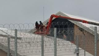 Prisoner taken off the roof at HMP Berwyn prison in Wrexham - BBC News
