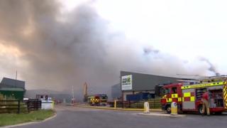 Staff help fire crews with Ancaster recycling fire clean-up - BBC News