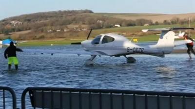 Shoreham airport under water after tidal surge - BBC News