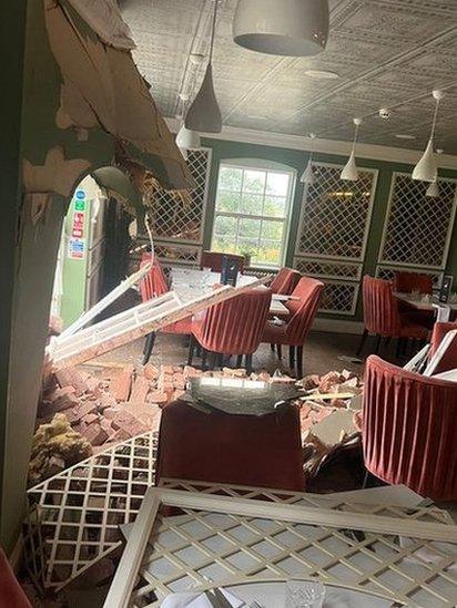 Stolen digger repeatedly rams into restaurant - BBC News