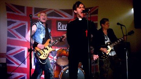 Punk vicar Philip Chew plays for Llanarmon faithful - BBC News