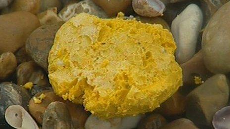 Waxy lumps washed up on North Yorkshire beaches - BBC News