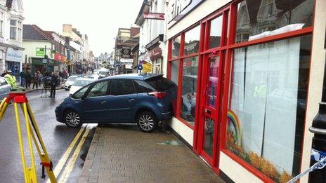 Camborne betting shop window car crash injures woman - BBC News