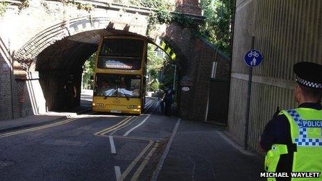 Westbourne mechanic gets bus wedged under bridge - BBC News
