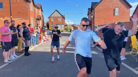 Rugby street hosts annual 80-metre Pride march - BBC News