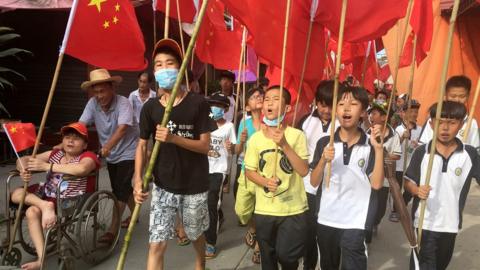 Wukan's 'rebel' villagers take to streets in ongoing protest - BBC News