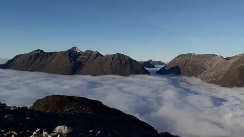 In pictures: Mountain summits 'float' above the clouds
