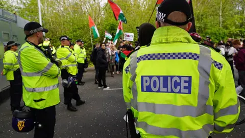 Police reduce drone factory protest area as two arrested