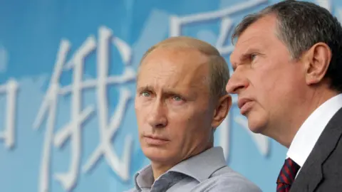 AFP President Putin (L) with Igor Sechin in Aug 2010 at the opening of a Russia-China oil pipeline