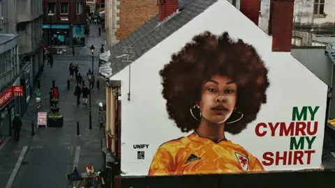 Cardiff mural celebrating diversity painted over by advert