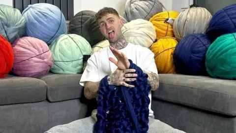 TikTok star the Tattooed Knitter sets world record for blanket knitting