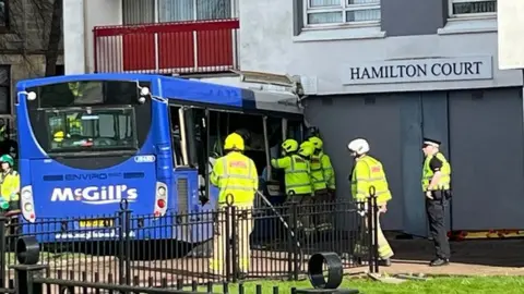 Five taken to hospital after bus crashes into Paisley flats
