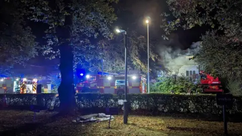 Roof collapses on building as crews tackle fire