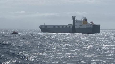 Cargo ship towed to safety after grounding near lighthouse - BBC News