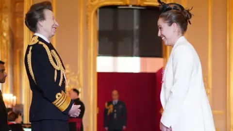 The Princess Royal hands rugby referee Sara Cox an MBE