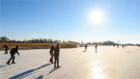 Dutch take to the ice as canals and lakes freeze over