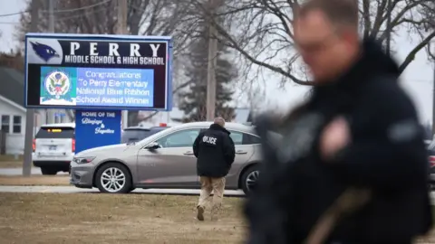 Iowa school principal distracted gunman before being shot
