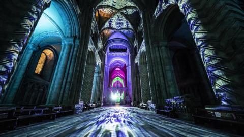 Durham Cathedral interior illuminated in stunning colours - BBC News