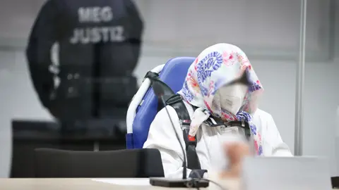 AFP 96-year-old defendant Irmgard F., a former secretary for the SS commander of the Stutthof concentration camp, sits in the courtroom at the start of her trial at the court room in Itzehoe, northern Germany, on October 19, 2021.