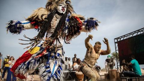 Senegal's Dakar Biennale: From red swimmers to floating teapots - BBC News