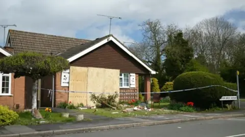 Two hurt when car hits house in Bedworth before being driven away