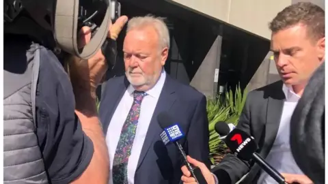 Ex-NHS boss has Australian corruption charges dropped