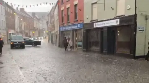 Heavy rain brings flash flooding and warning of disruption