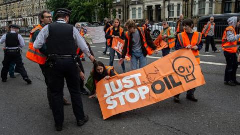 Met Police officer drags Just Stop Oil protester along road - BBC News
