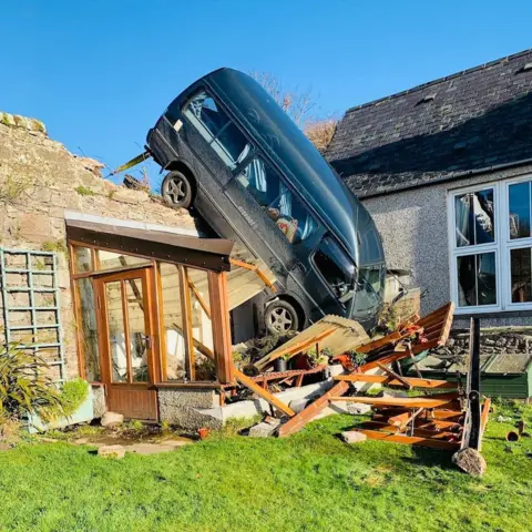 Gardener's lucky escape as van smashes greenhouse