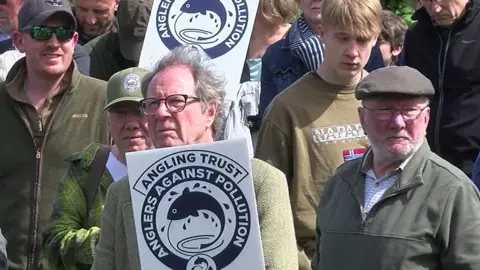 Dozens join protest against sewage discharges into rivers