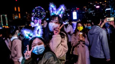 Covid pandemic dampens New Year celebrations around the world - BBC News