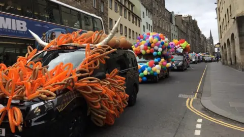 Children's taxi outing to review water bombing during parade