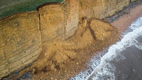 West Bay: Three rockfalls on Dorset's Jurassic Coast block beach - BBC News