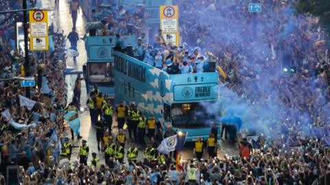 Manchester City fans and players celebrate historic Treble in the rain ...