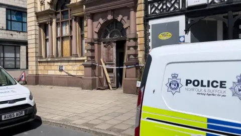 Two charged as police investigate cannabis factory in old bank