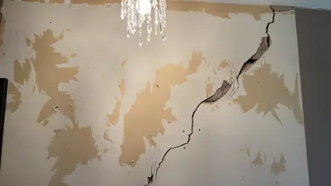 Bedford family fear taking a bath after cracks appear in Clarion house