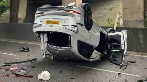 Driver arrested after car crashes off interchange flyover