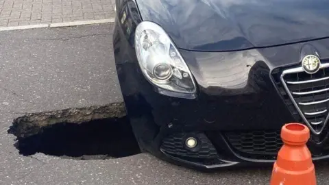 Witham: Driver in shock as sinkhole swallows wheel