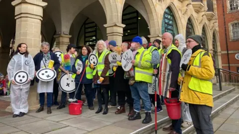 Northampton protestor fakes pollution death at council meeting