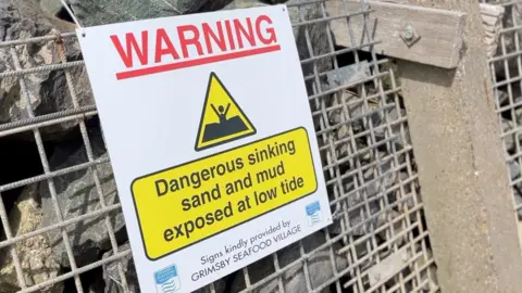 Rise in people stuck in beach mud along the east coast prompts warning