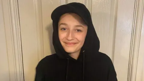 School protests force U-turn after sick pupil banned from wearing cap