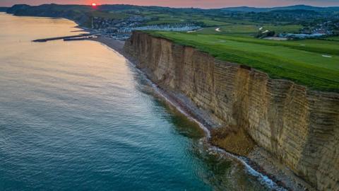 Jurassic Coast: Youngsters pose for photos on rock fall cliff edge ...