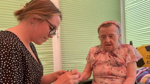 Woman with Down's Syndrome 'an inspiration' at 73 - BBC News
