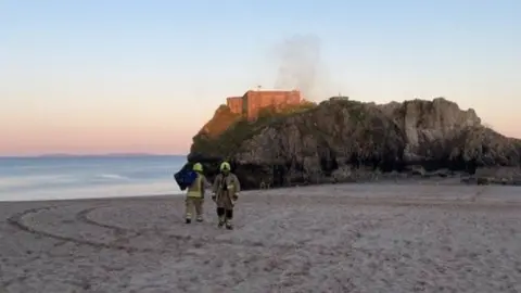 Smoke over Tenby after 19th Century fort rubbish fire